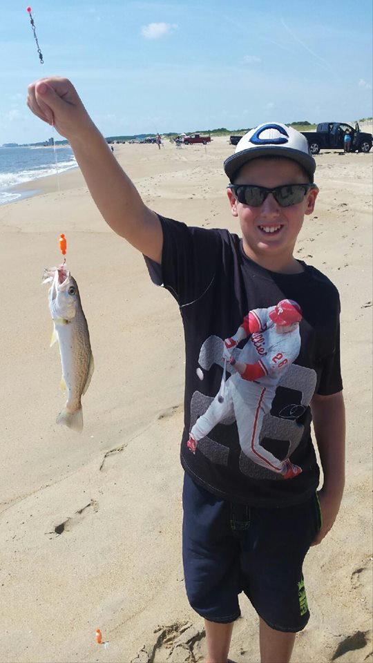 Aiden with a lil weakfish from the surf - delaware-surf-fishing.com