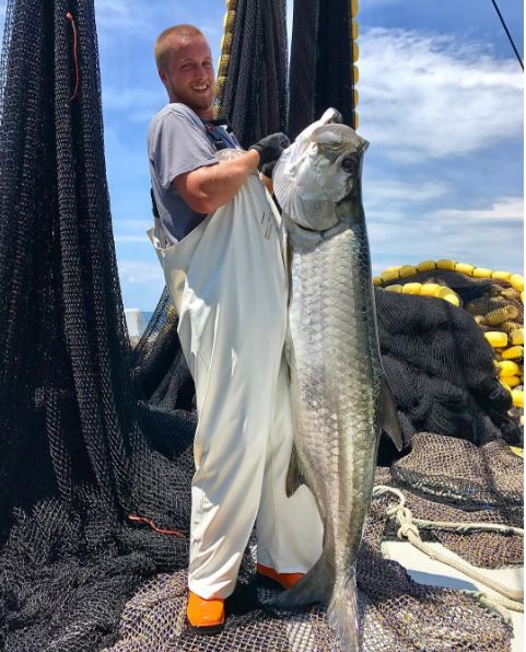 Blake Walker holding one of the tarpon netted off the Jersey Coast ...