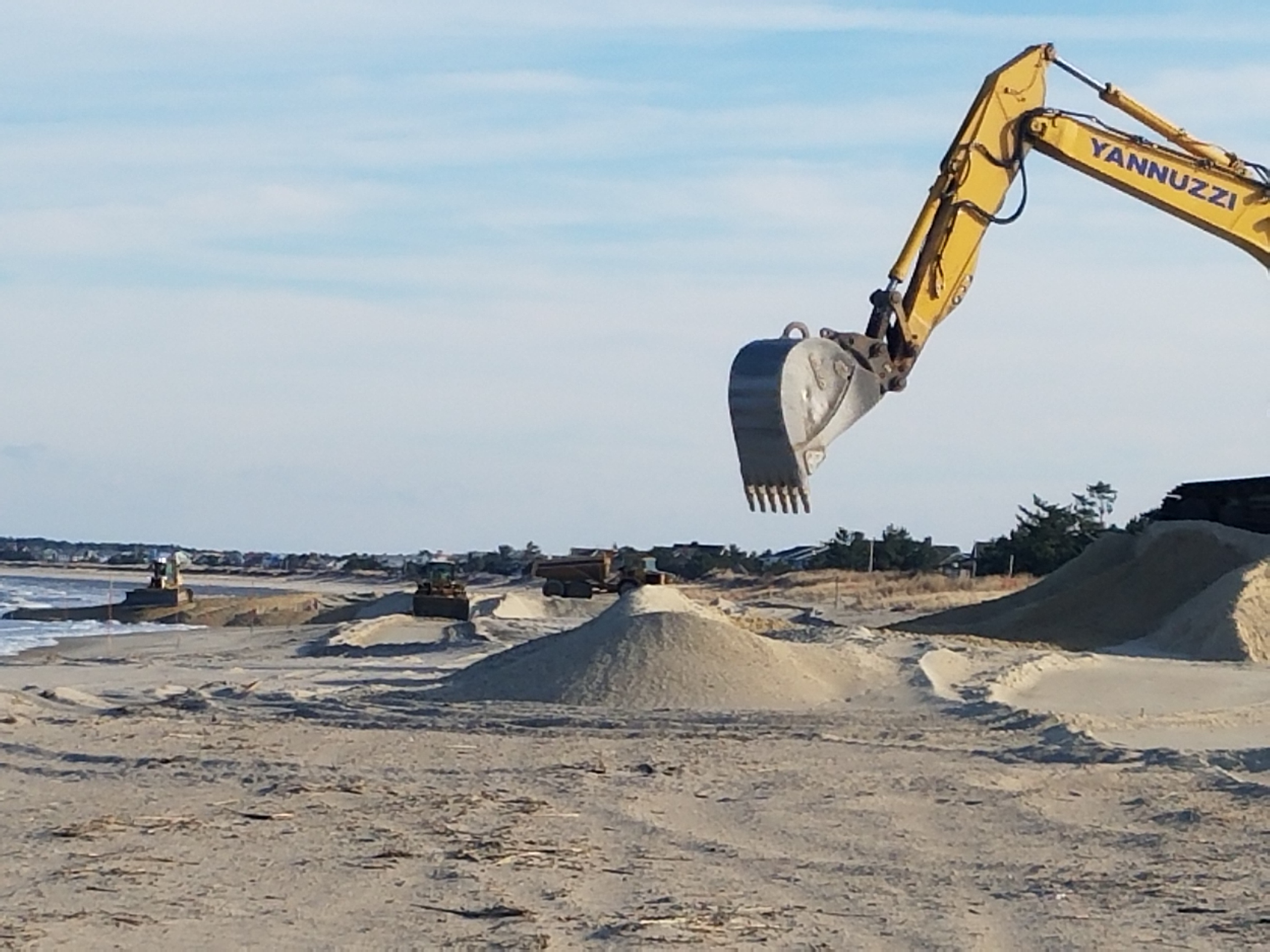 moving sand form piles to the trucks for beach replenishment - delaware ...