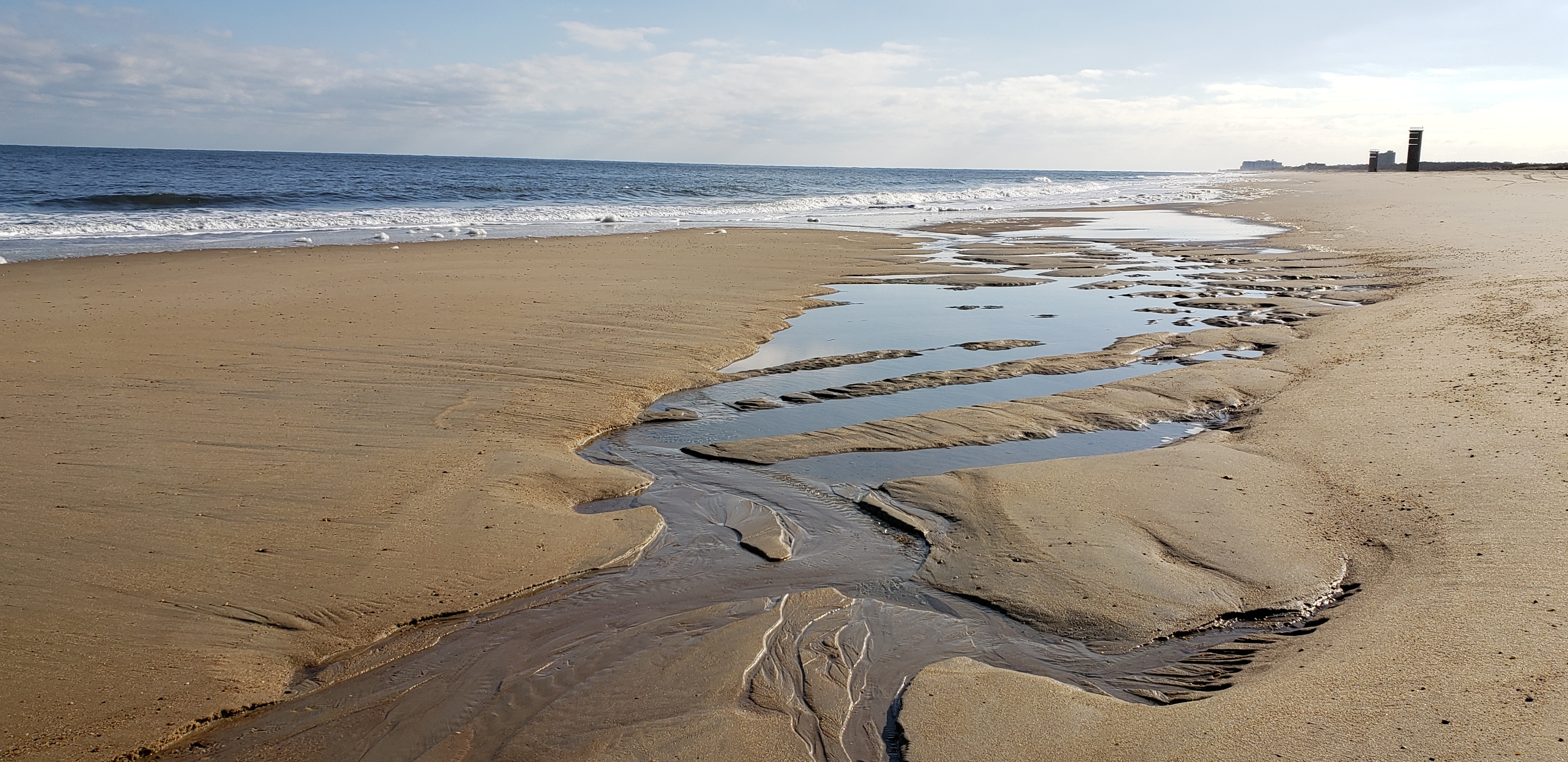 Washed out cut area exposed at low tide at Herring Point Beach in Cape ...
