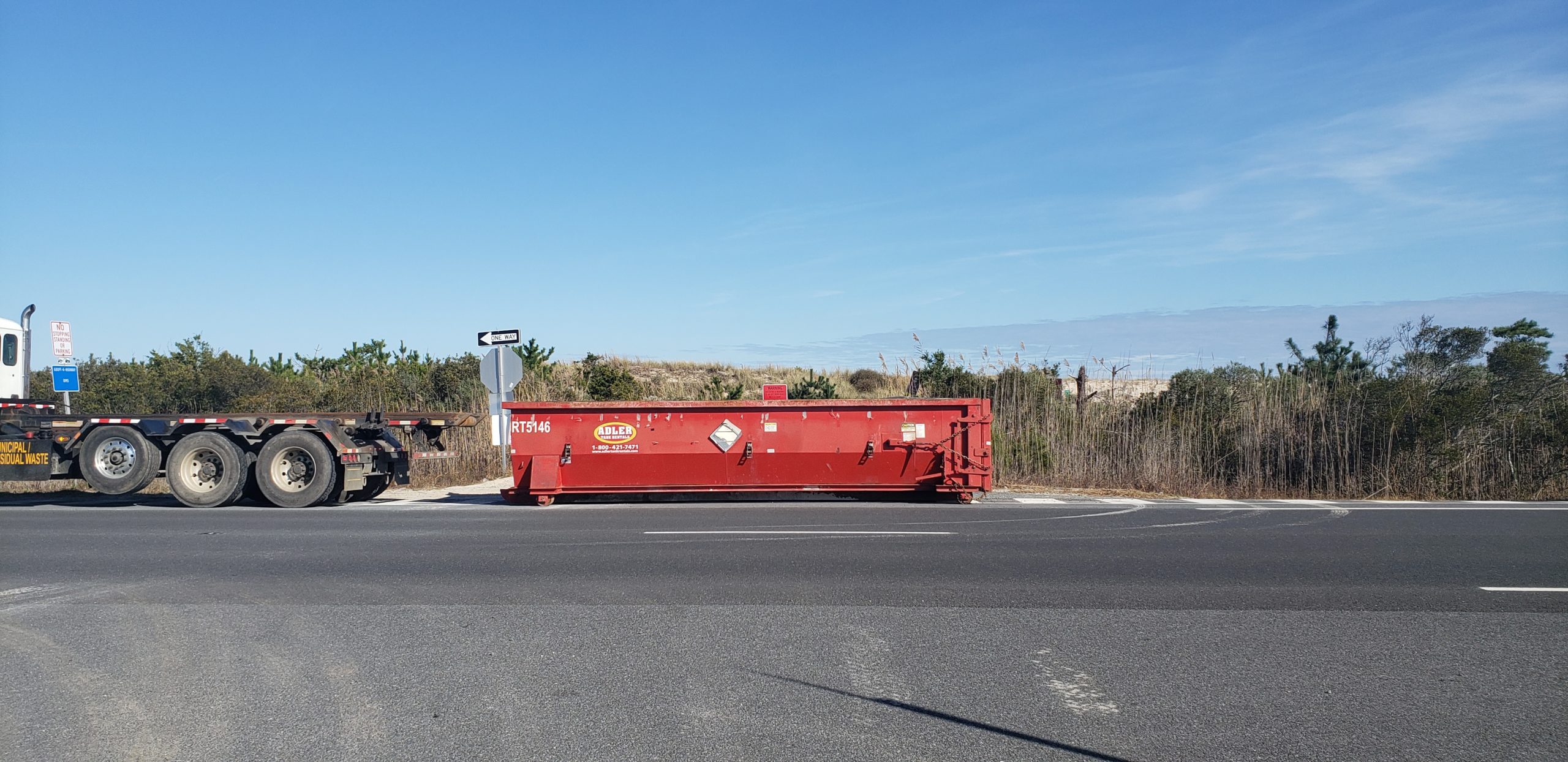 Dumpster staged at Faithful Steward crossing to collect ily beach ...
