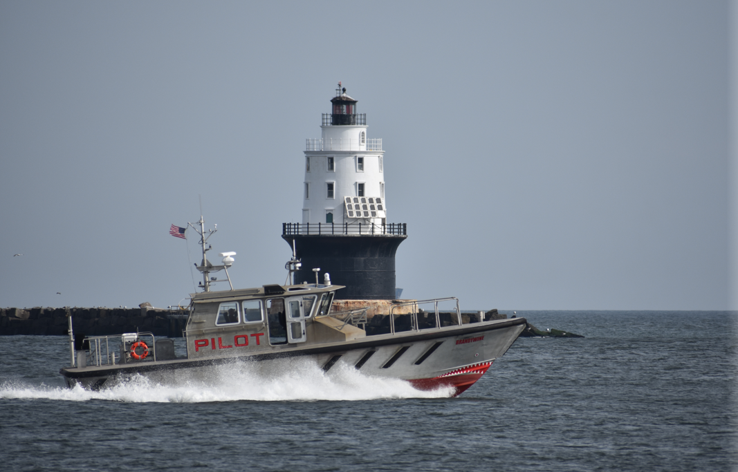 Harbor of Refuge Lighthouse and the pilot boat - delaware-surf-fishing.com